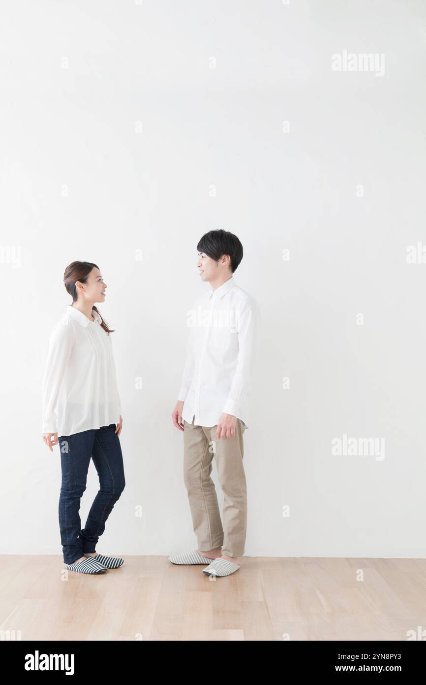 Young couple facing each other Stock Photo - Alamy
