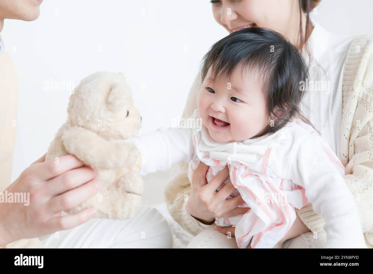 Baby delighted by stuffed animal Stock Photo - Alamy