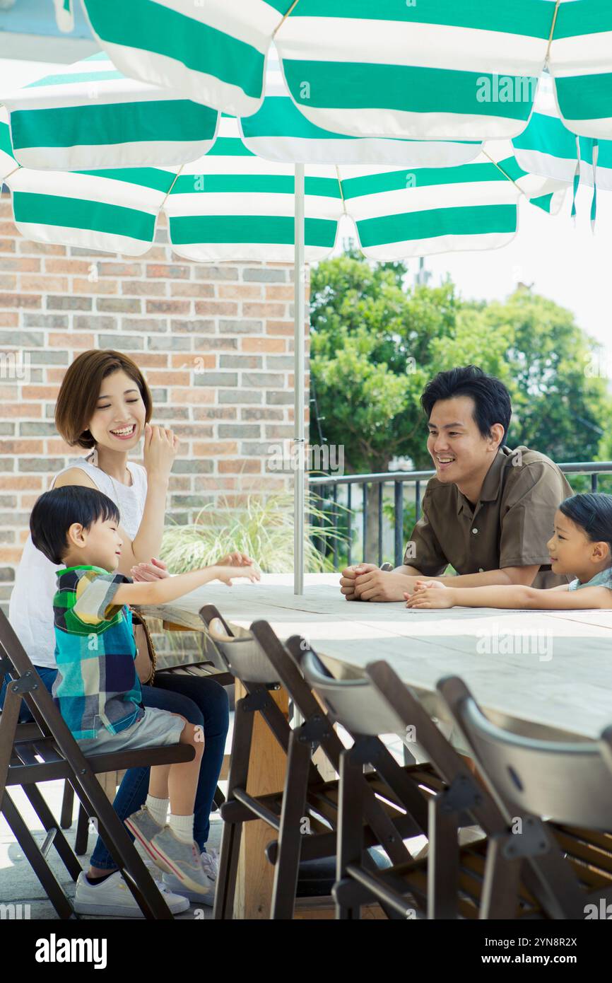 Family having a conversation on the terrace Stock Photo - Alamy