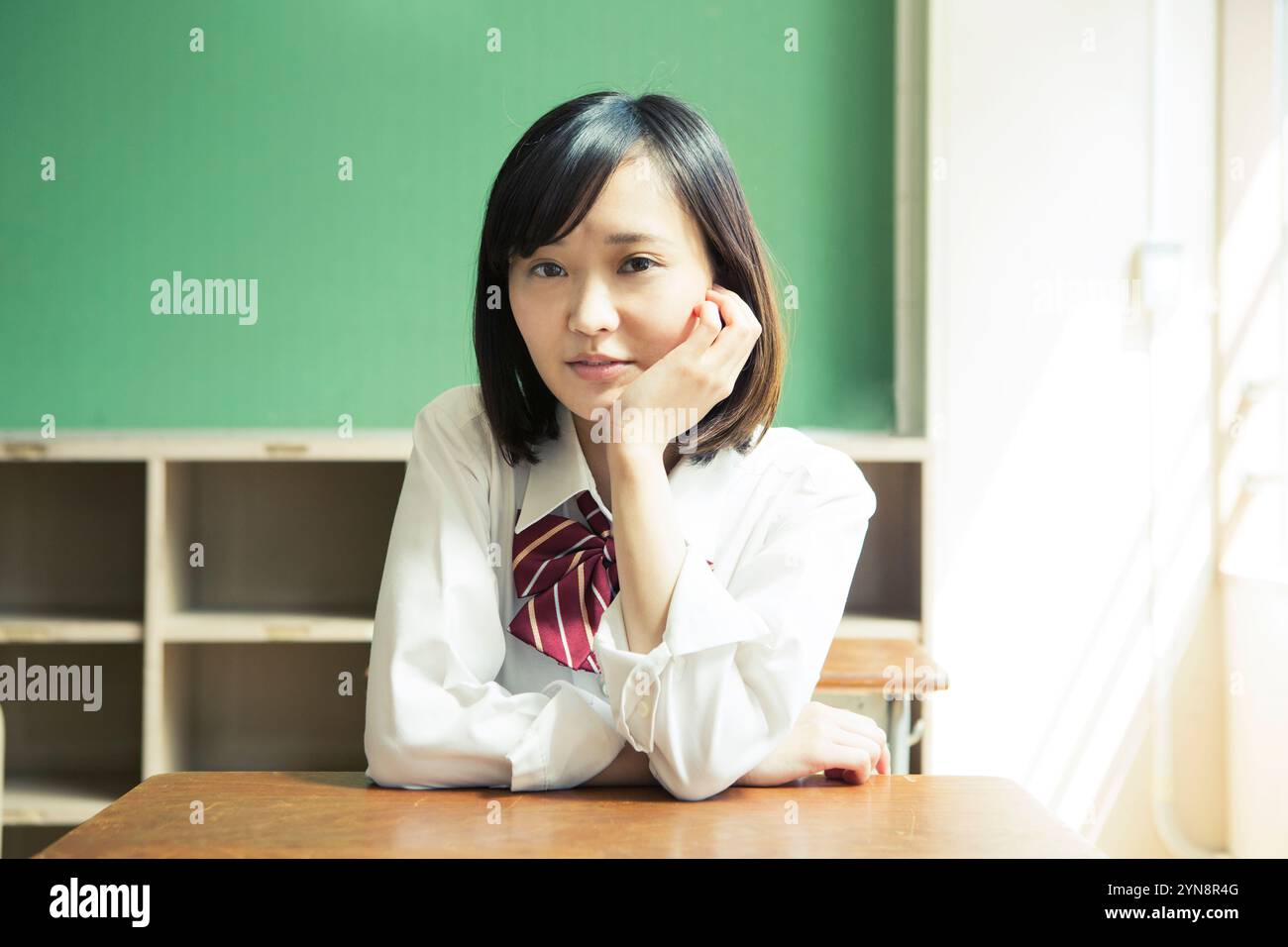 Female high school student with cheekbones in a classroom Stock Photo ...