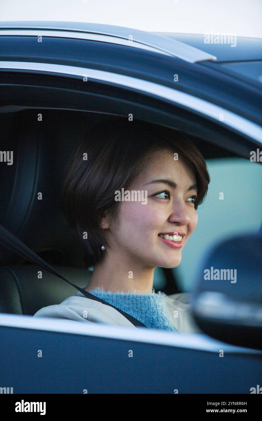 Person smiling while driving hi-res stock photography and images - Alamy