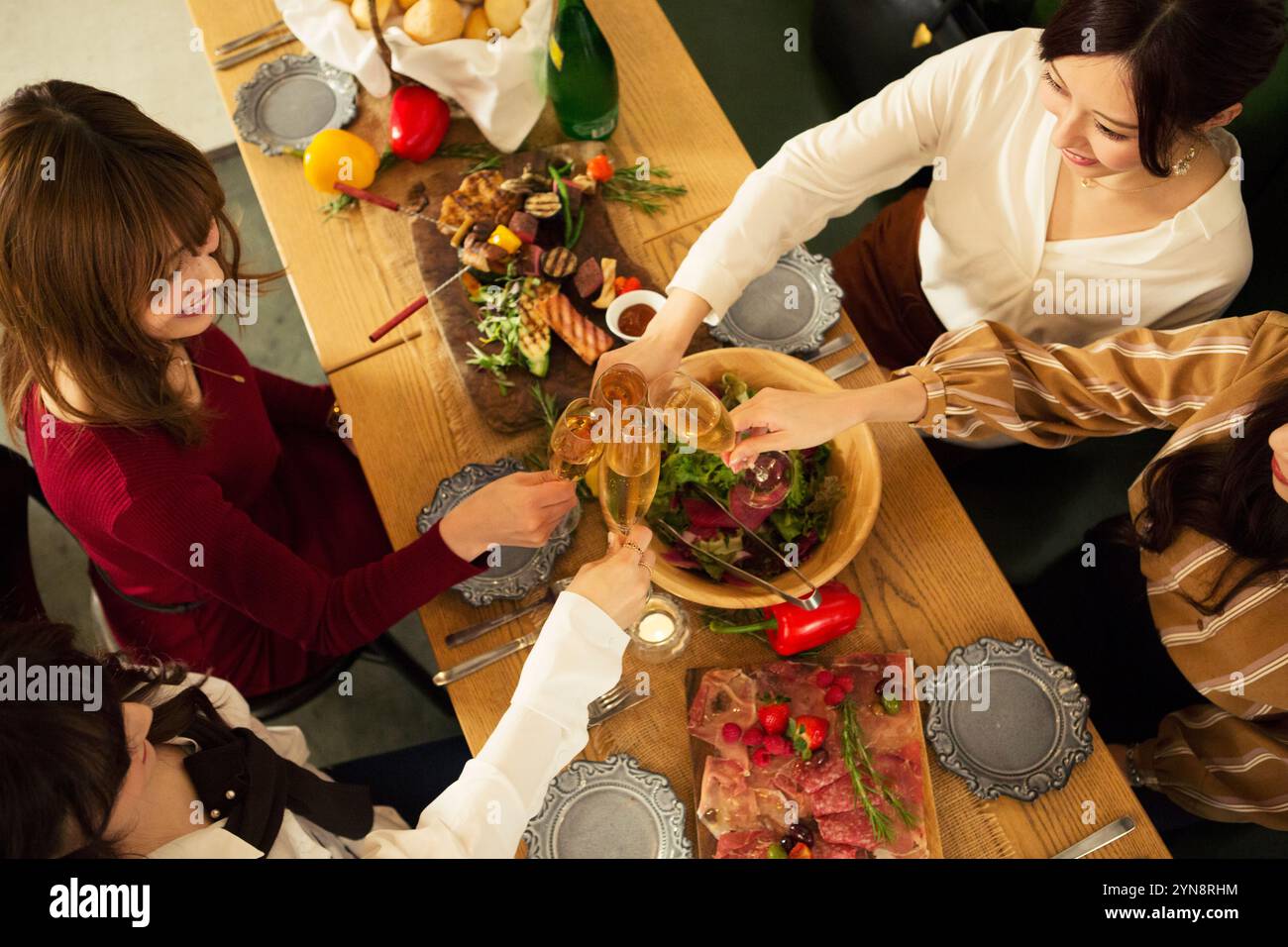 Four women in their 20s making a toast Stock Photo - Alamy
