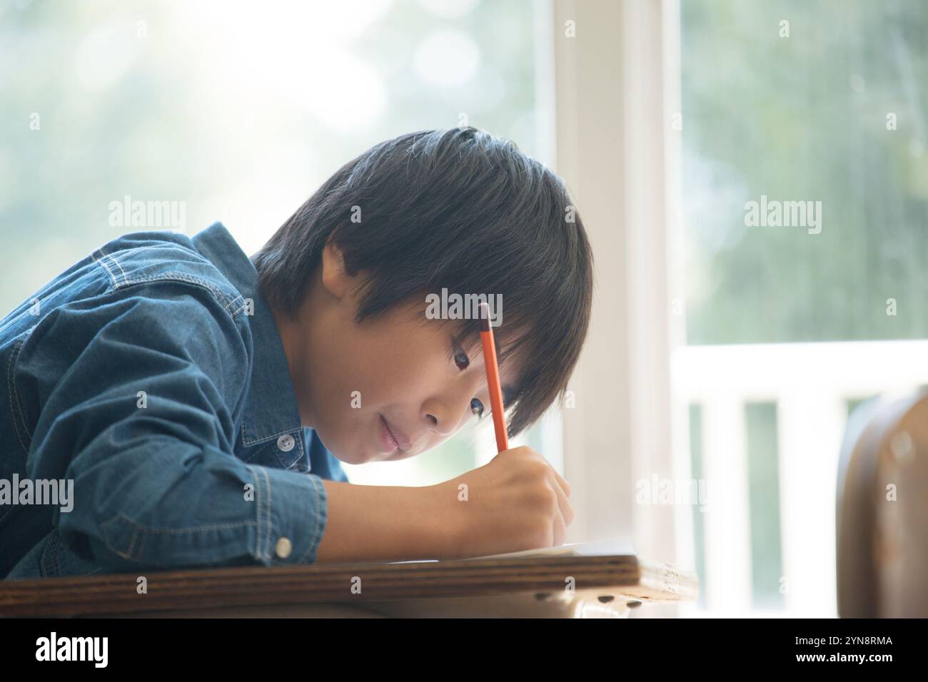 Primary school boy solving a problem Stock Photo - Alamy