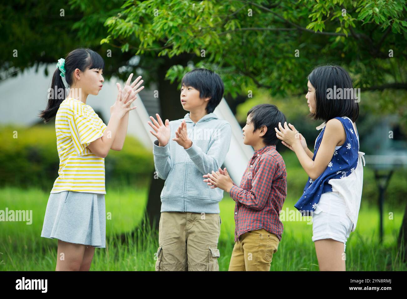 Primary school boys and girls playing with hands Stock Photo - Alamy