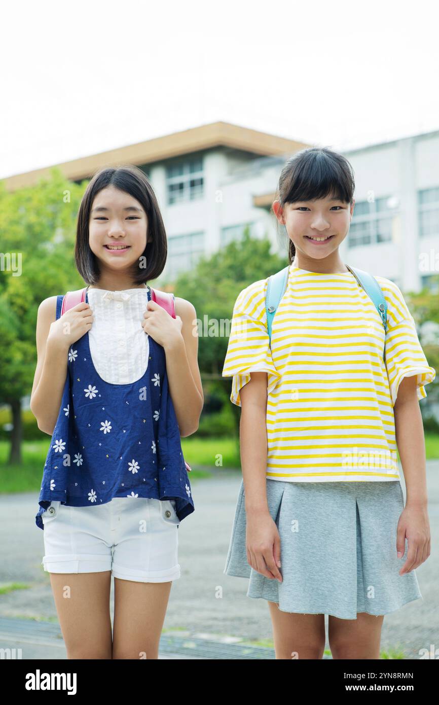 Two primary schools girls standing in front of the school gate Stock ...