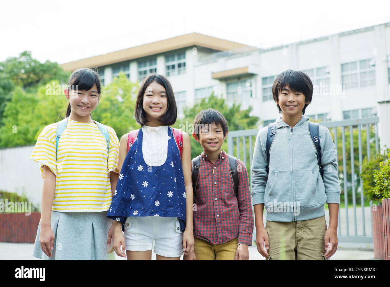 Primary schools boys and girls standing in front of the school gate ...
