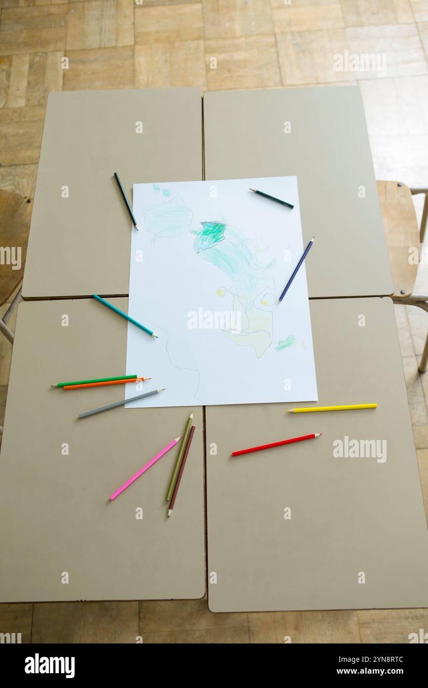 Drawing paper and coloured pencils on desk Stock Photo - Alamy