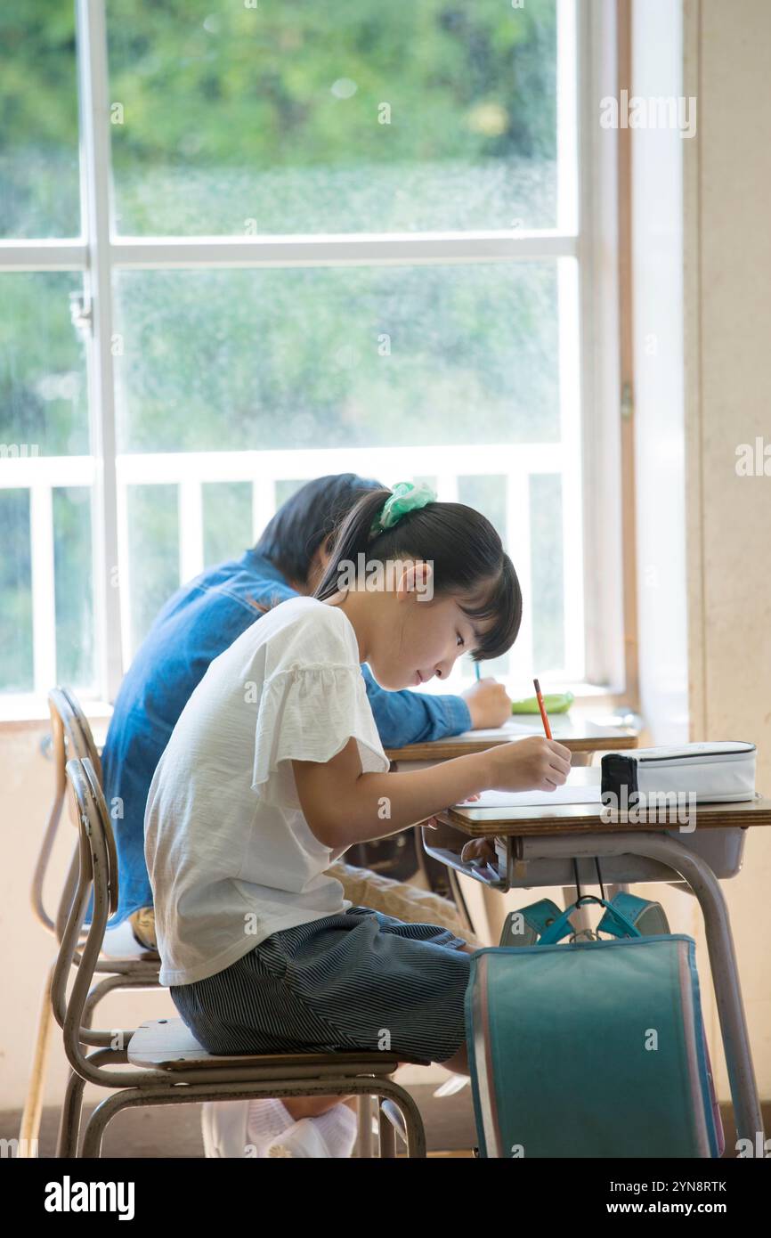 Men and women studying in a classroom Stock Photo - Alamy