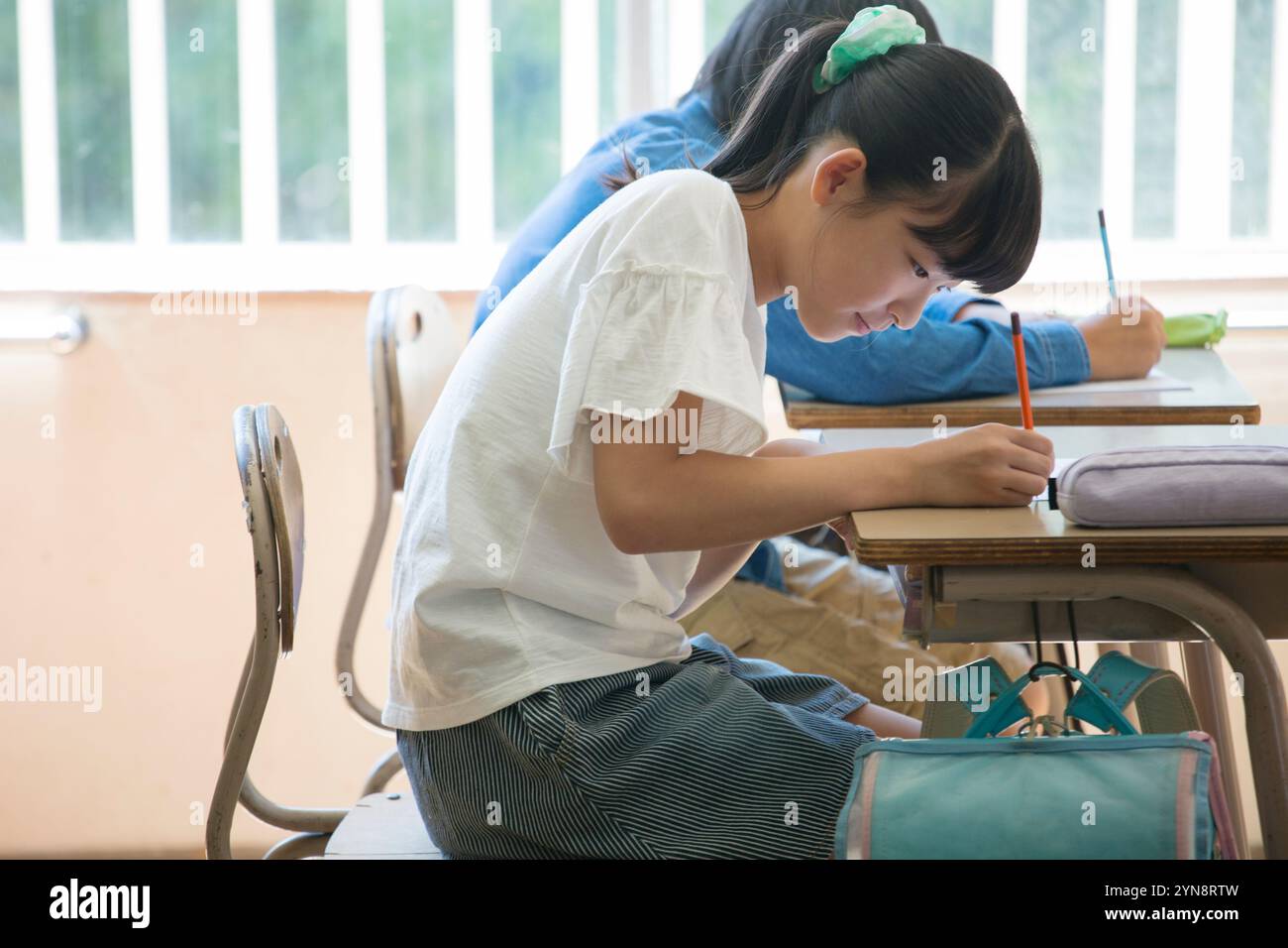 Men and women studying in a classroom Stock Photo - Alamy