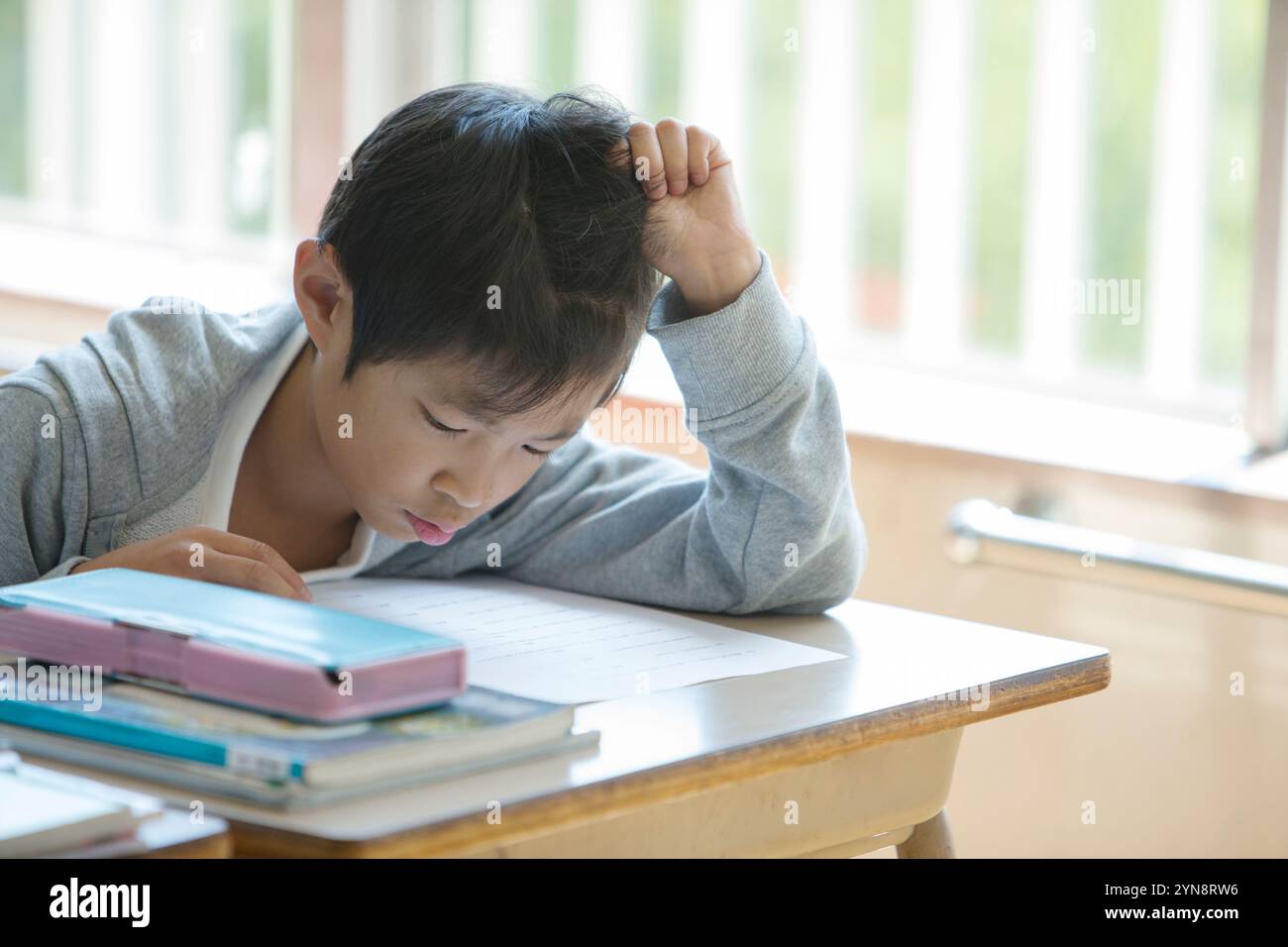 Boy thinking during class Stock Photo - Alamy