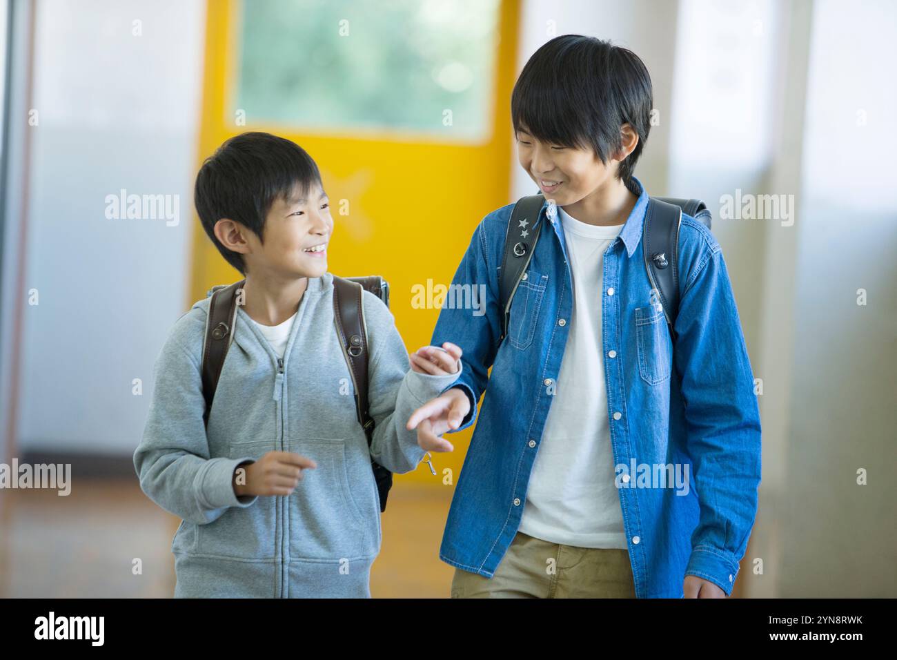 Two smiling primary schools boys talking in the corridor Stock Photo ...