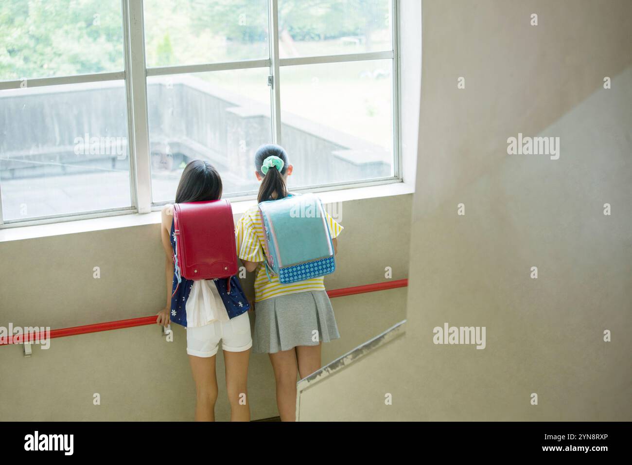 Two primary schools girls looking out Stock Photo - Alamy