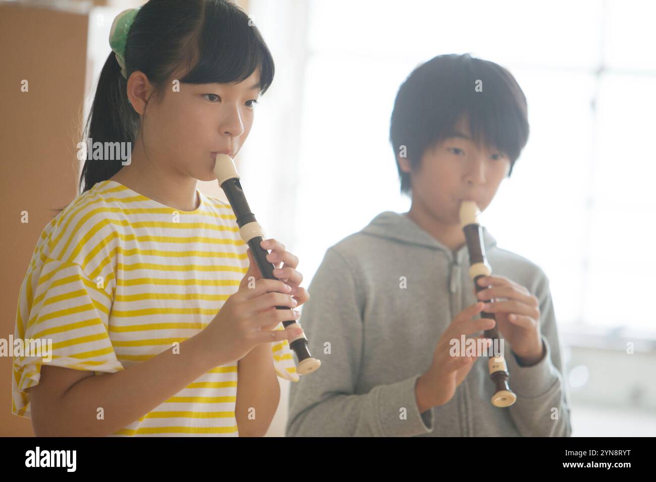 Male and female primary schools students playing in ensemble Stock ...