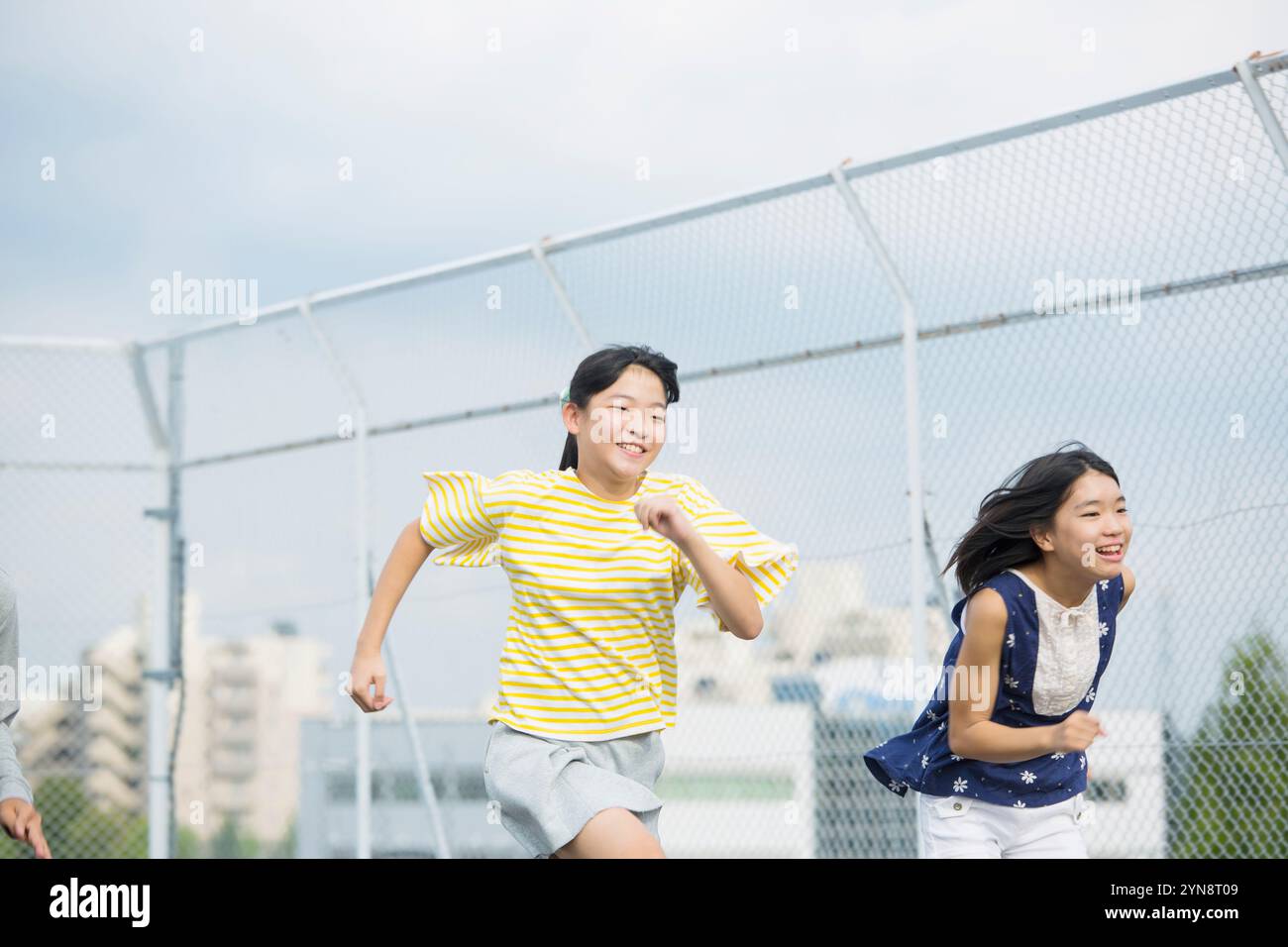 Primary school girls running on the rooftop Stock Photo - Alamy