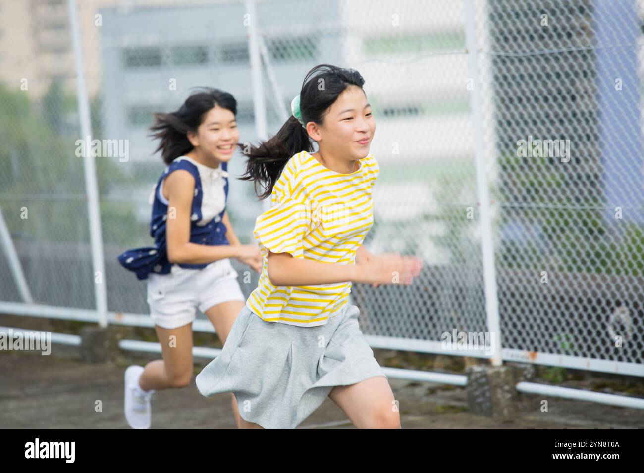 Primary school girls running on the rooftop Stock Photo - Alamy