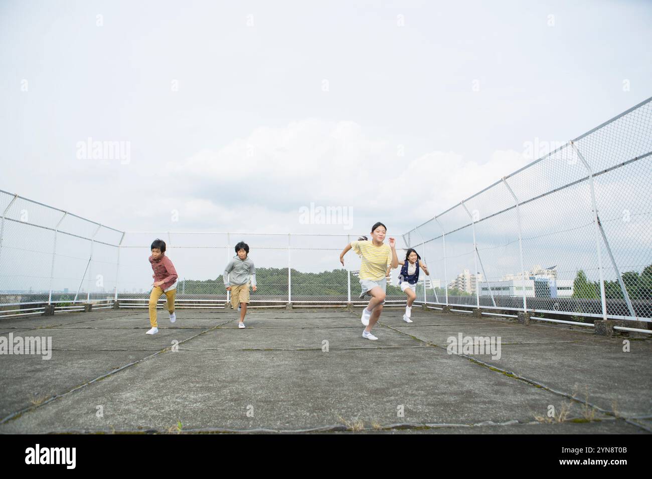 Primary school boys and girls running on the rooftop Stock Photo - Alamy