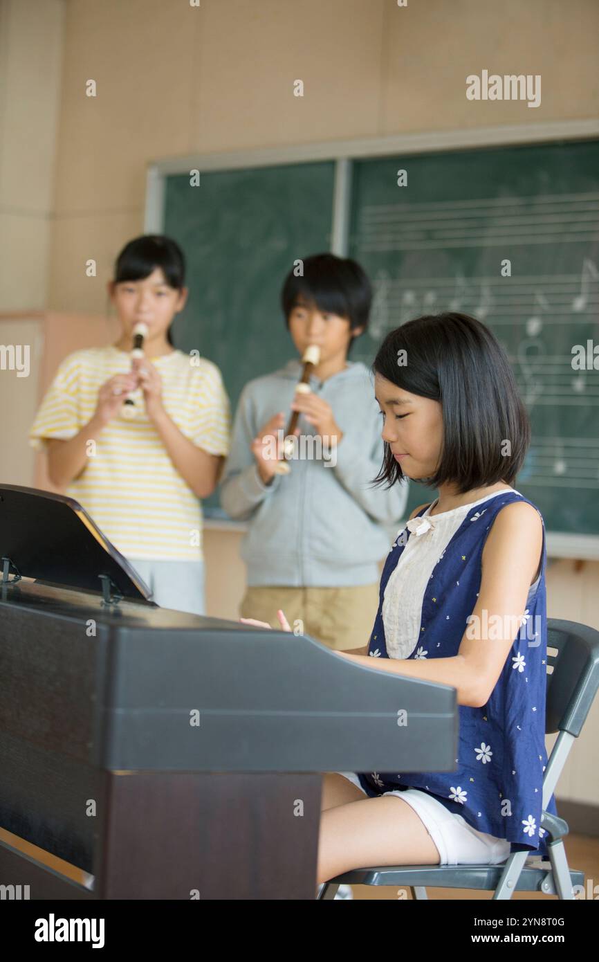 Male and female primary schools students playing in ensemble Stock ...