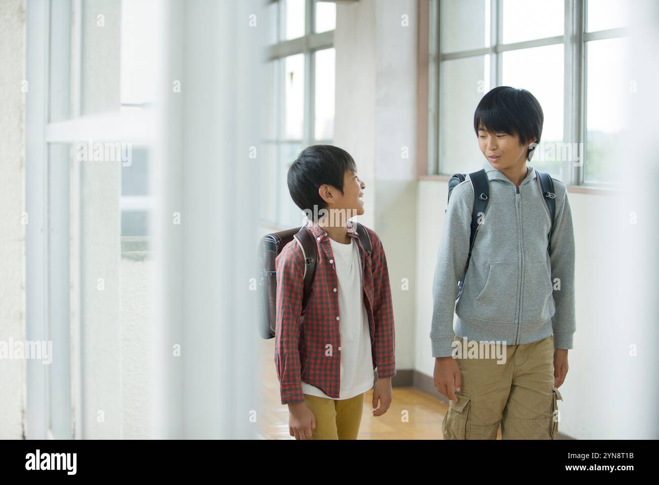 Two smiling primary schools boys talking in the corridor Stock Photo ...