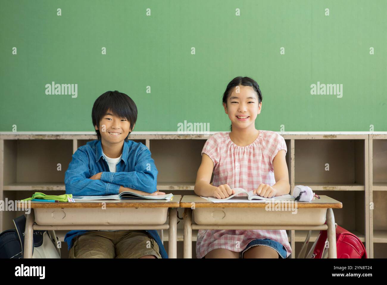 Smiling primary school boys and girls studying Stock Photo - Alamy
