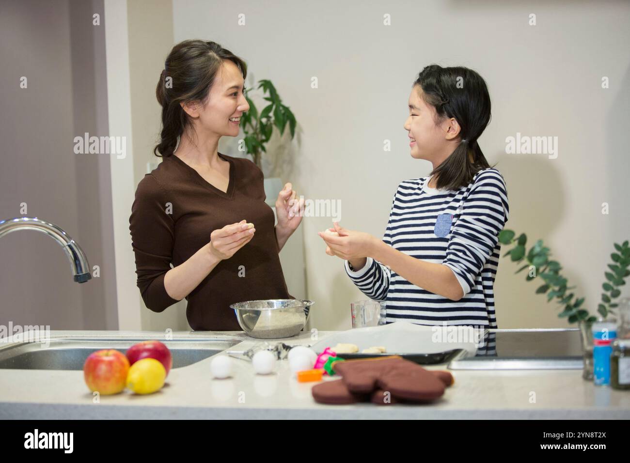 Parent and child making sweets with a smile Stock Photo - Alamy