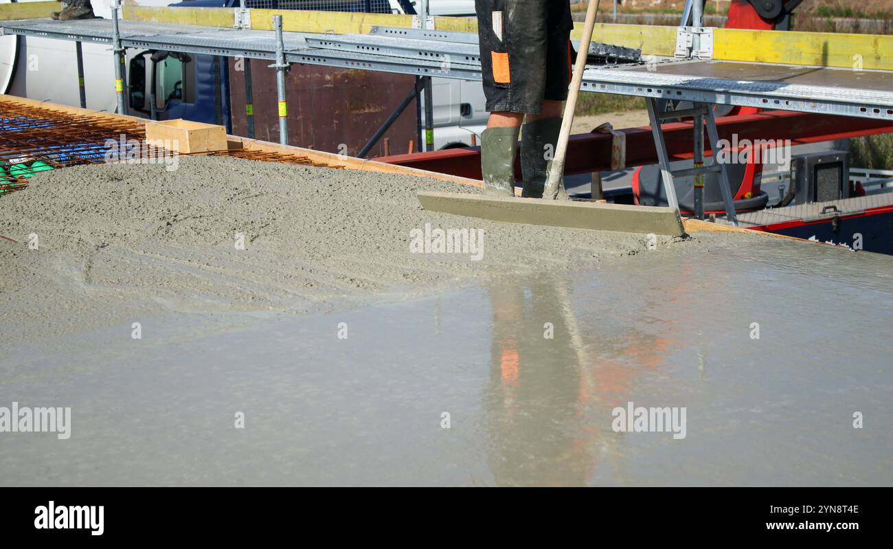 Workers filling the second floor ground with concrete, core and shell ...