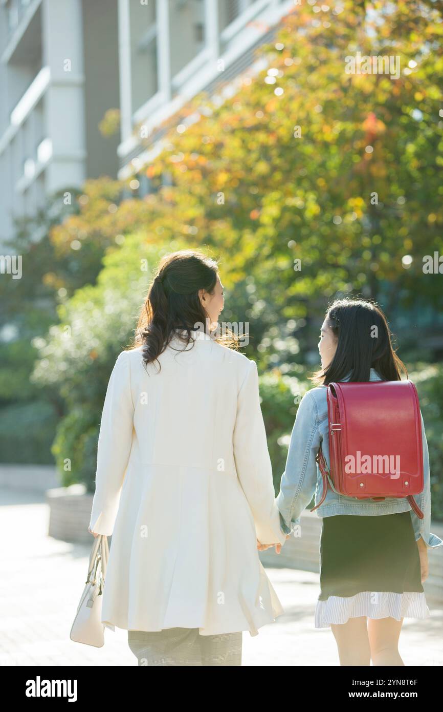 Woman child walking back view town hi-res stock photography and images ...