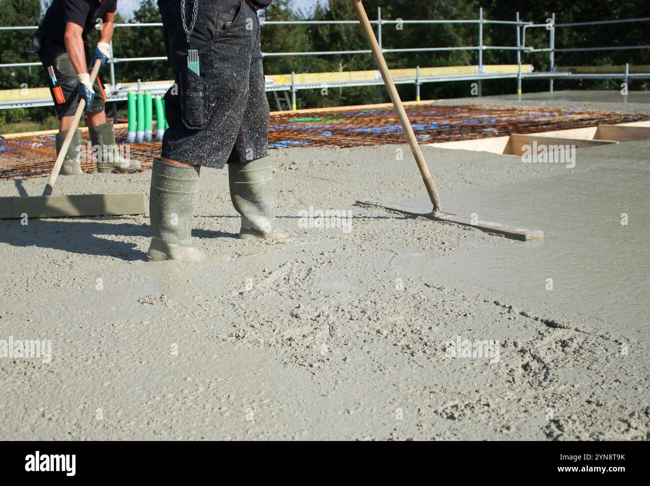 Workers filling the second floor ground with concrete, core and shell ...