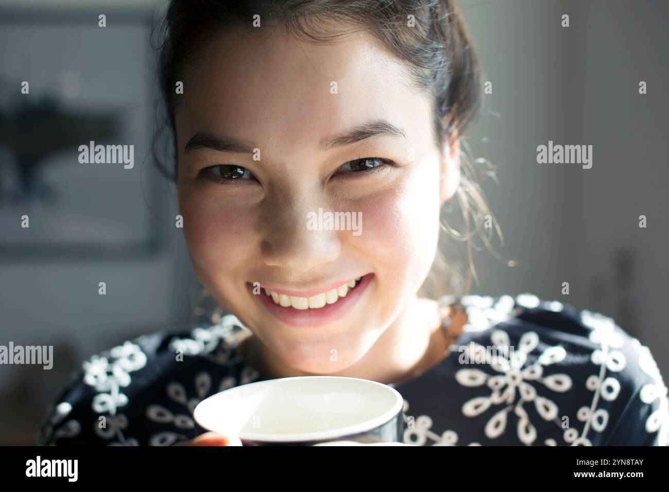 Smiling 20s woman with coffee cup Stock Photo - Alamy