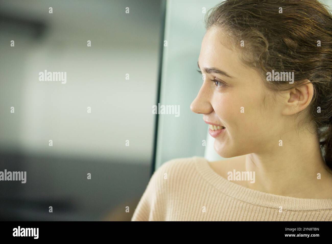 Smiling 20s foreign model in profile Stock Photo - Alamy