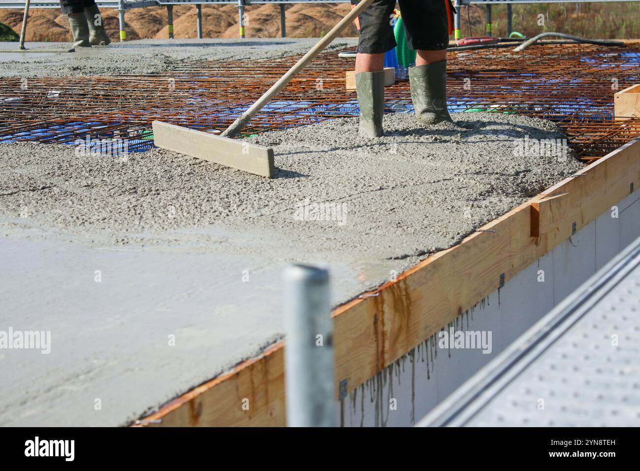 Workers filling the second floor ground with concrete, core and shell ...