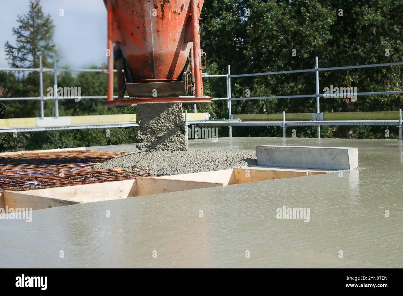 Workers filling the second floor ground with concrete, core and shell ...