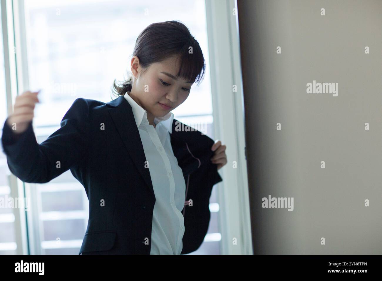 Putting on suit hi-res stock photography and images - Alamy