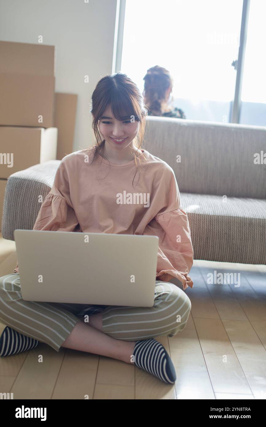 Women in their 20s operating a computer in a room Stock Photo - Alamy