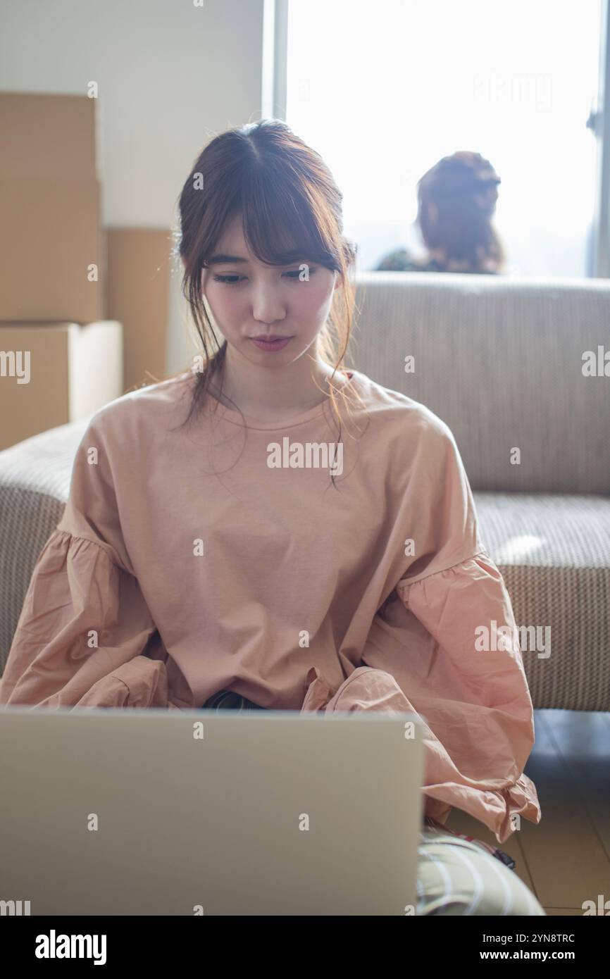 Women in their 20s operating a computer in a room Stock Photo - Alamy