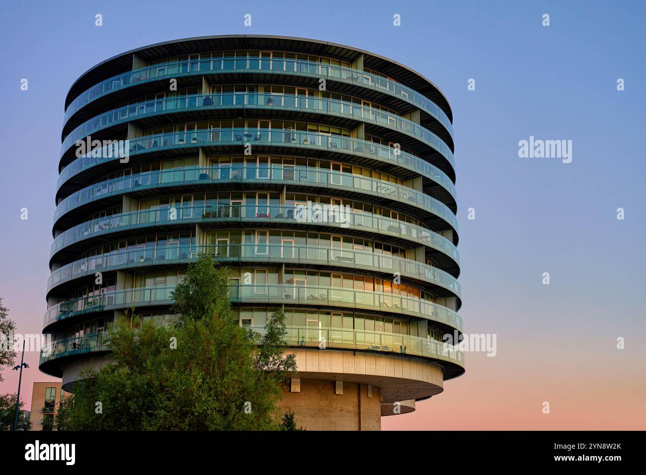 Modern round building with glass facade. Modern residential building ...