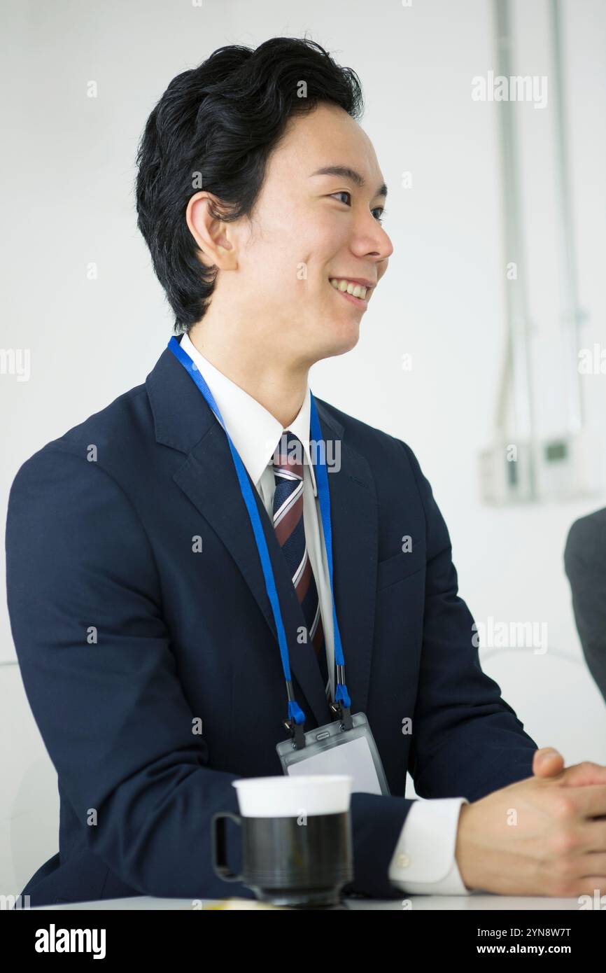 Smiling man in his 20s in suit Stock Photo - Alamy