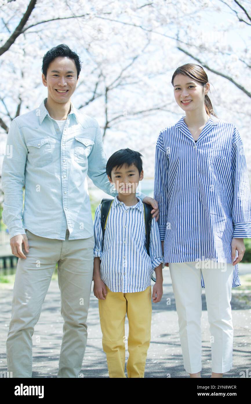 Portrait of smiling family standing under cherry tree Stock Photo - Alamy