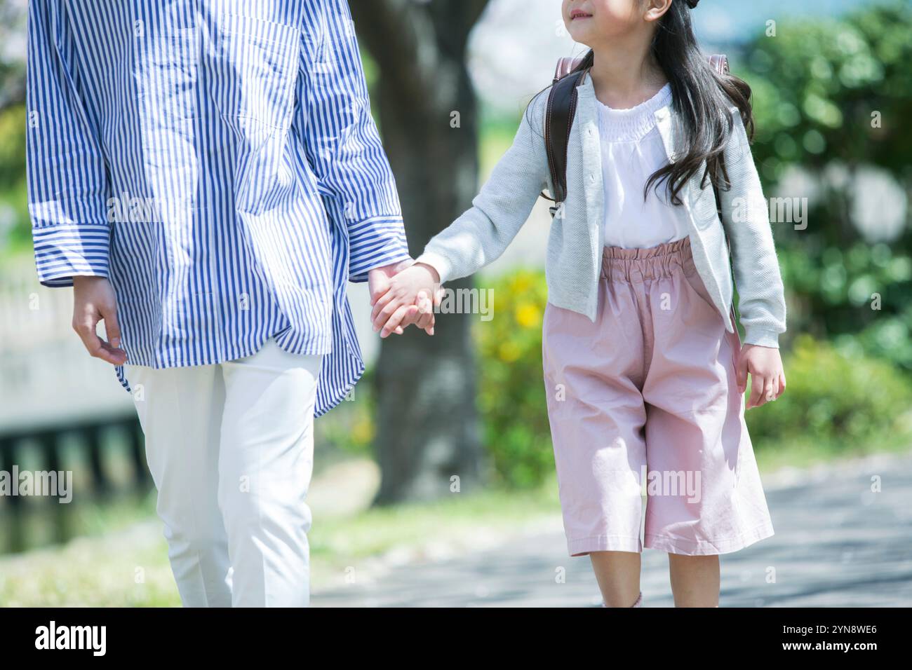 Parent and child walking hand in hand Stock Photo - Alamy