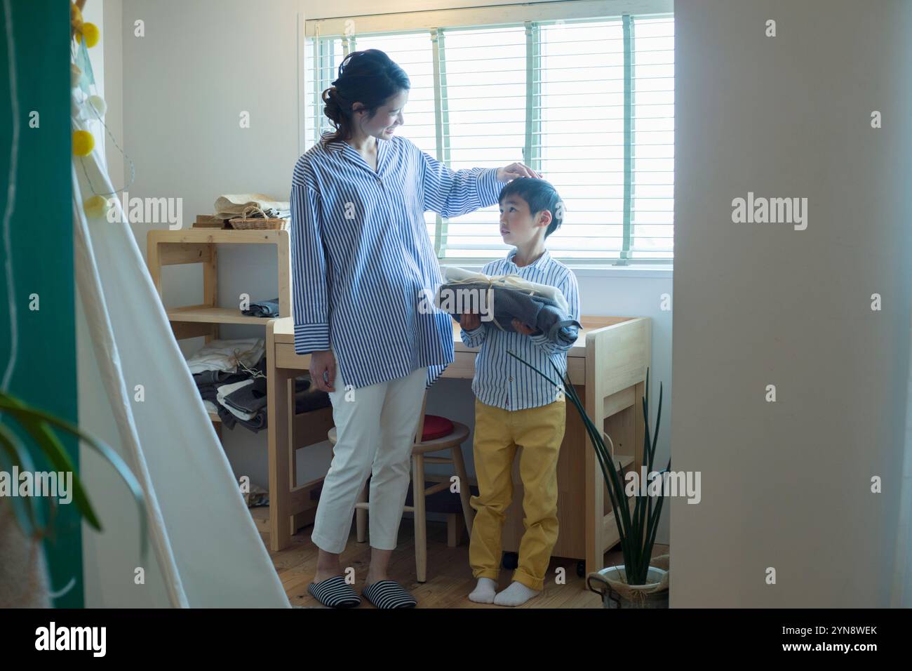Happy parent and child helping out at home Stock Photo - Alamy