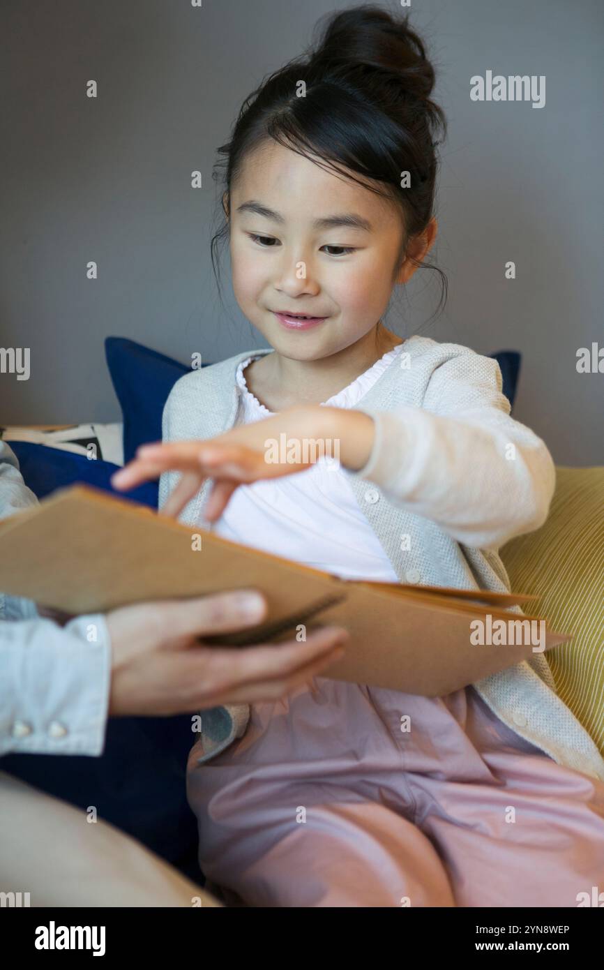 Child girl book laugh hi-res stock photography and images - Alamy