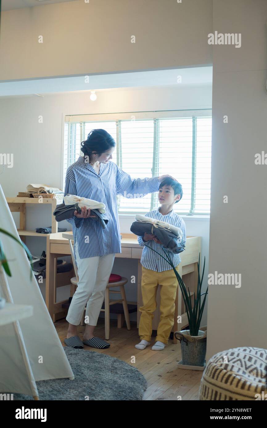Happy parent and child helping out at home Stock Photo - Alamy