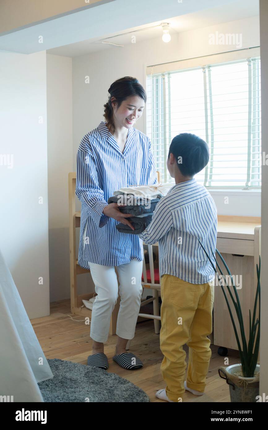 Happy parent and child helping out at home Stock Photo - Alamy
