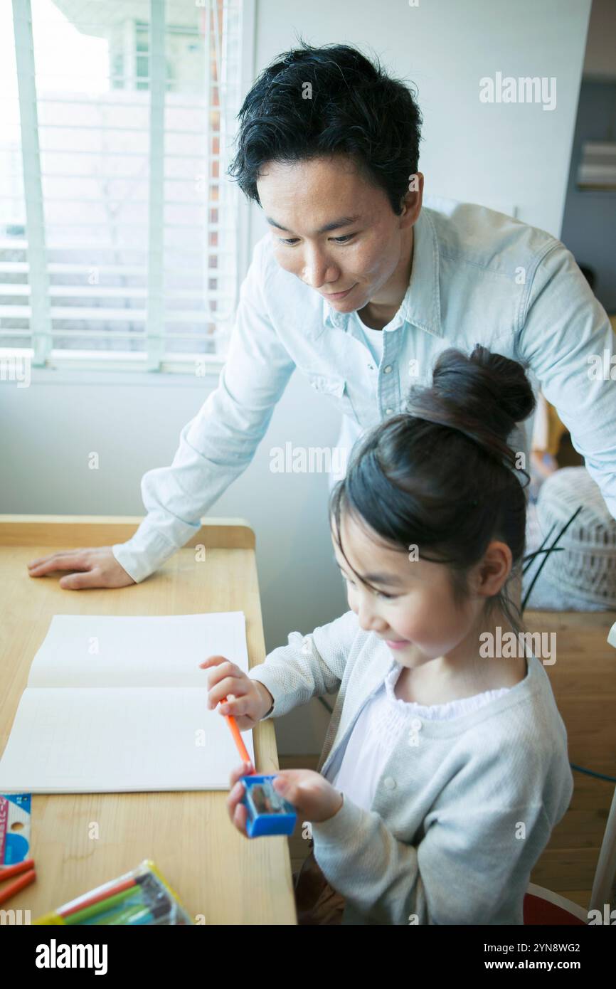 Girl being taught to study in her room Stock Photo - Alamy