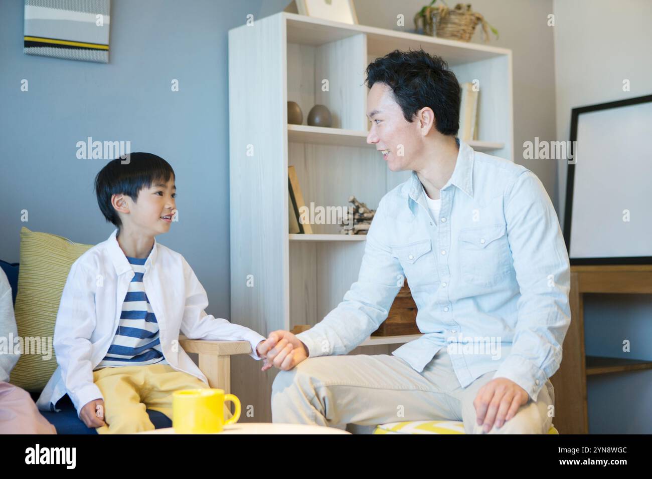 Happy parents and children talking in the living room Stock Photo - Alamy