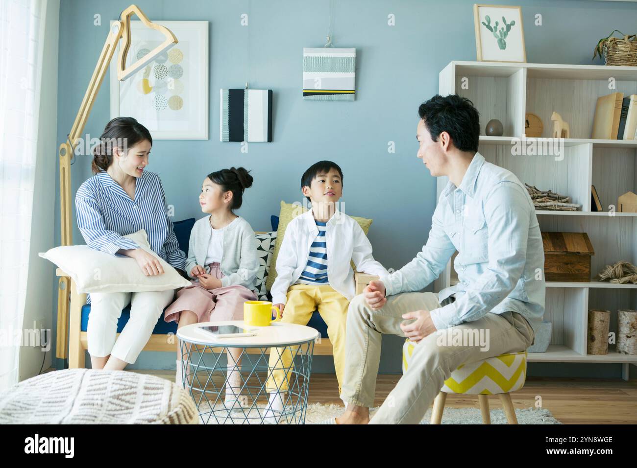 Happy family talking in the living room Stock Photo - Alamy