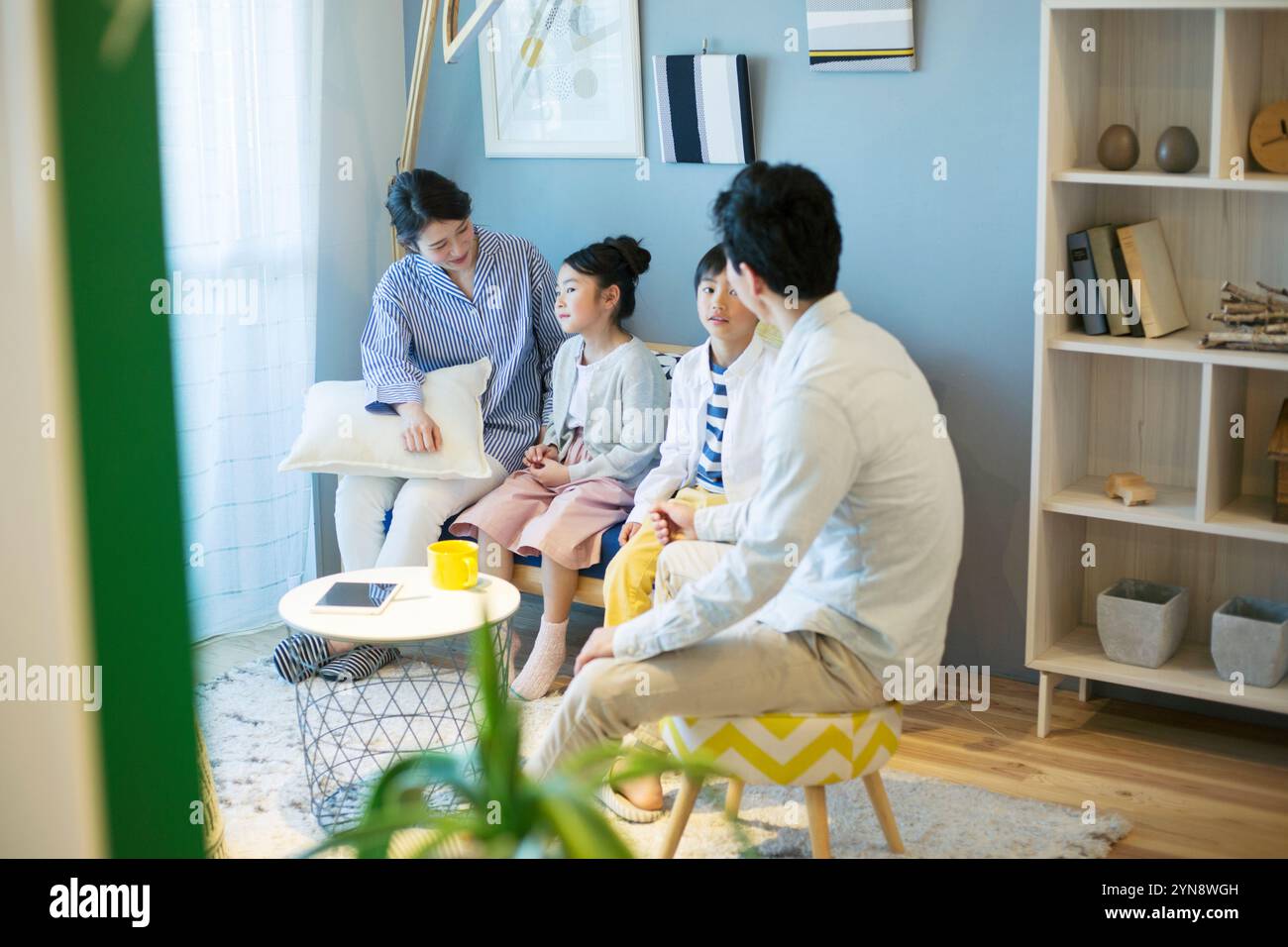 Happy family talking in the living room Stock Photo - Alamy