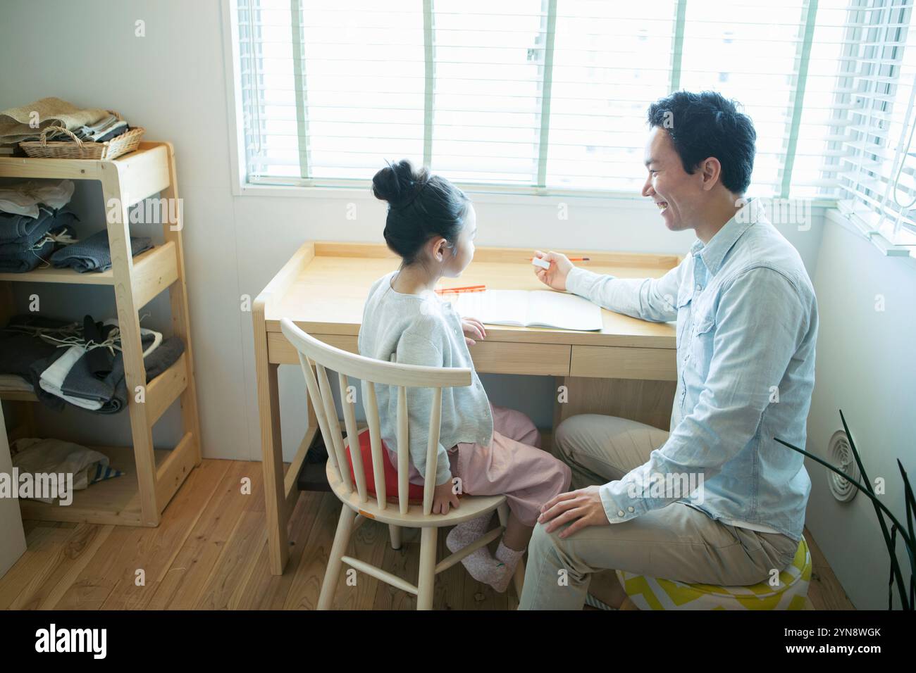 Girl being taught to study in her room Stock Photo - Alamy