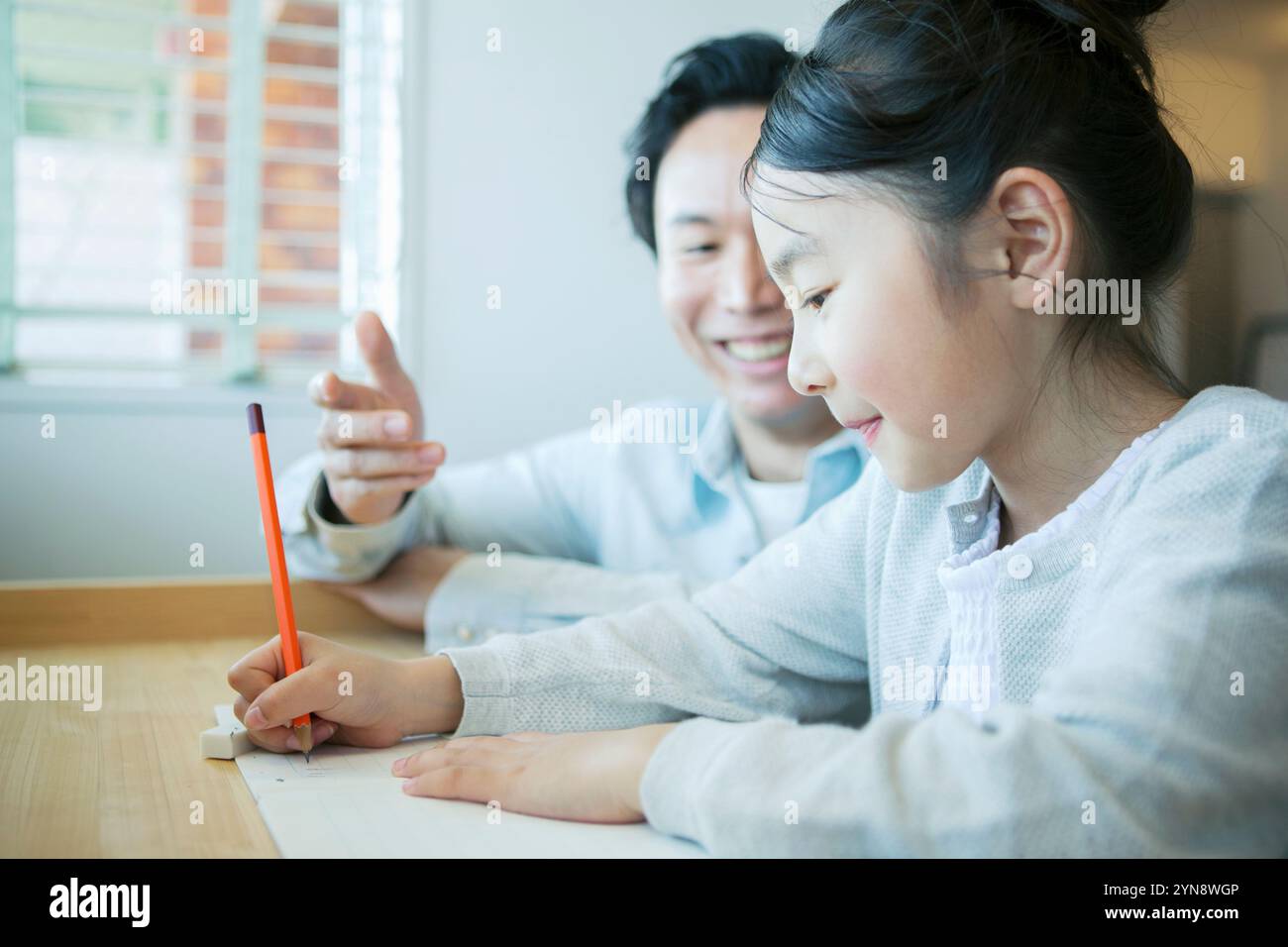 Girl being taught to study in her room Stock Photo - Alamy