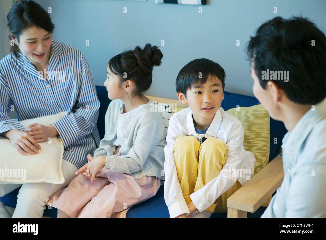 Happy family talking in the living room Stock Photo - Alamy