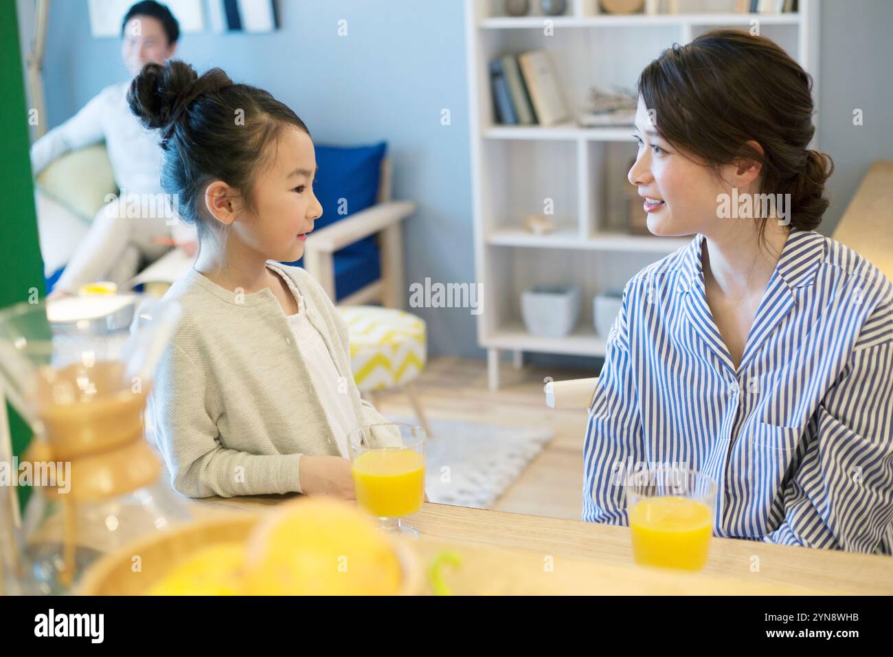Happy parents and children talking in the living room Stock Photo - Alamy